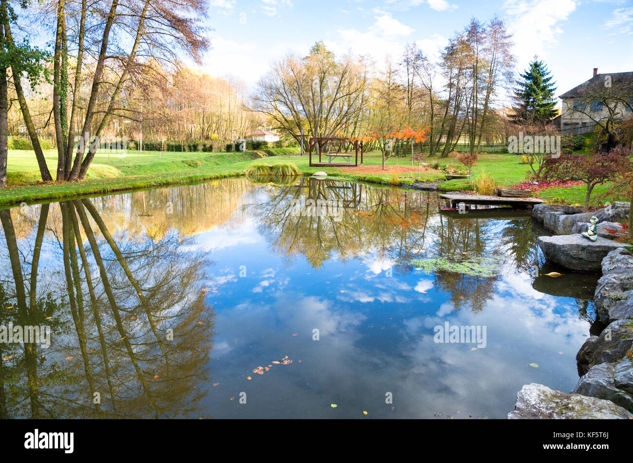 beautiful autumn concept with pond and trees around Stock Photo - Alamy