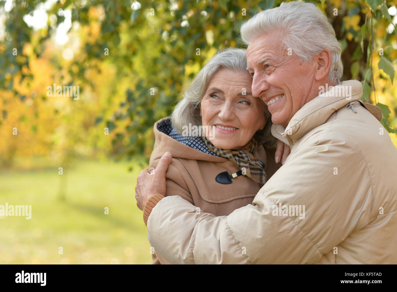 senior couple hugging in the park Stock Photo - Alamy