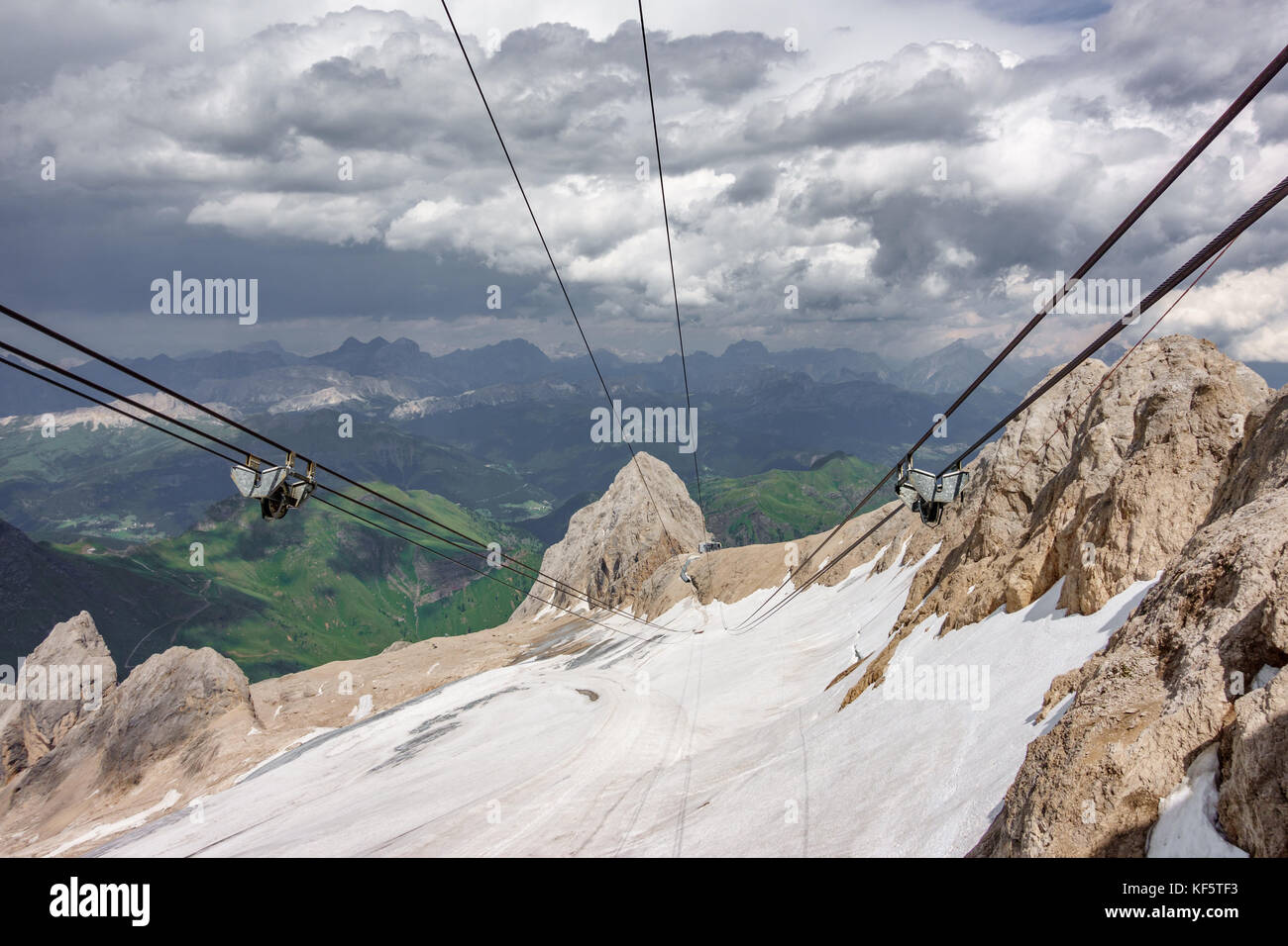 Cable car cables and wheels against vertical rock, Marmolada Peak Stock ...