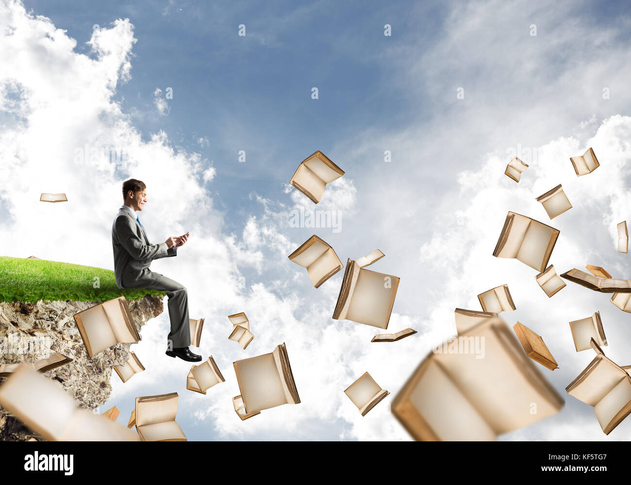 Man using smarphone and many books flying in air Stock Photo - Alamy