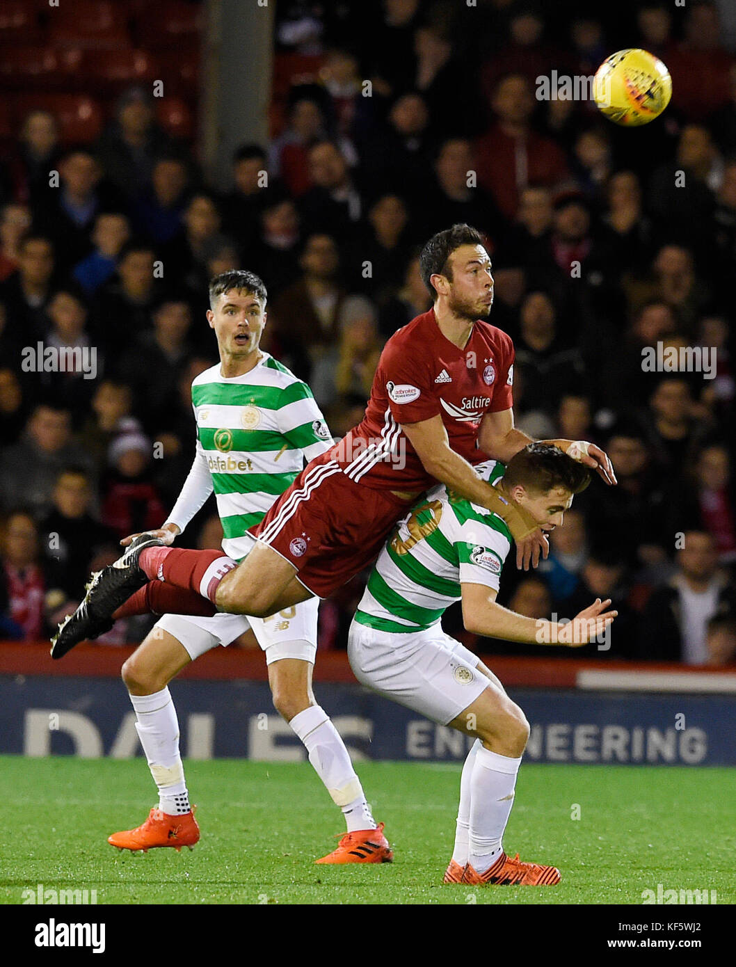 Aberdeen's Andrew Considine heads clear from Celtic's James Forrest ...