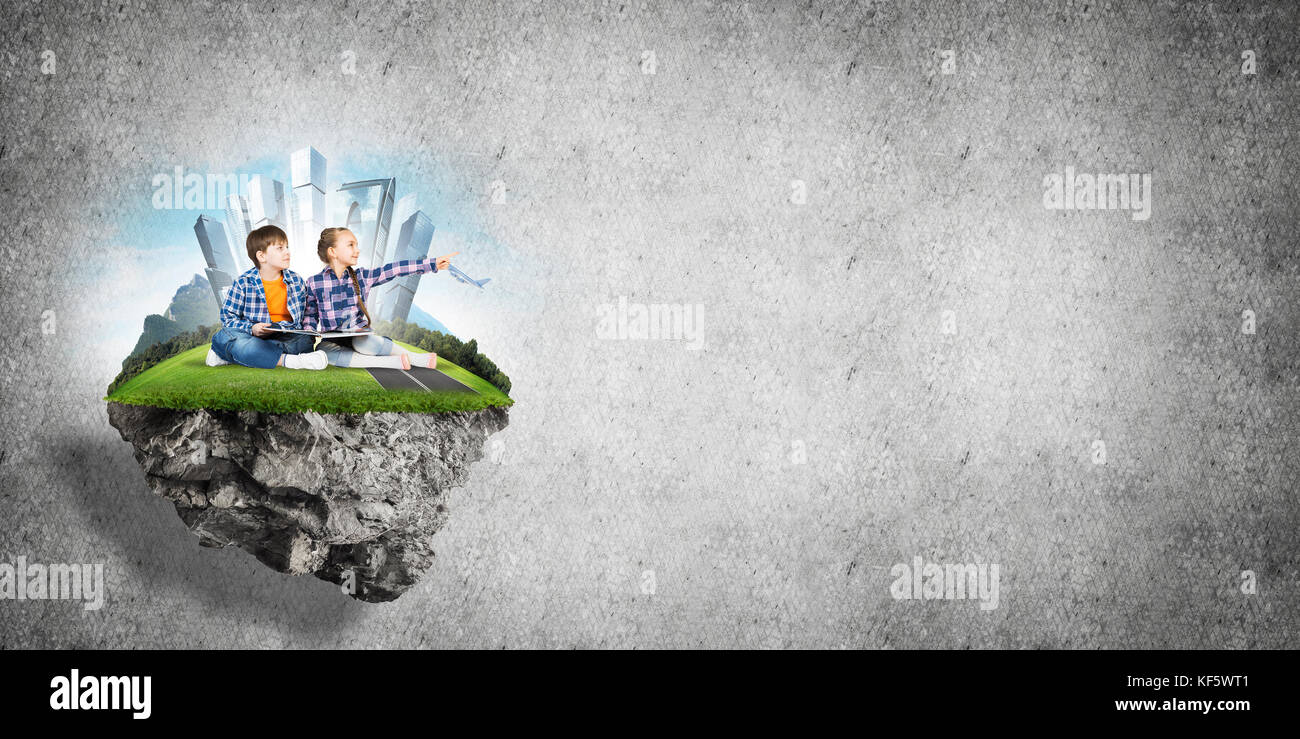Two kids of school age with book exploring this great world Stock Photo ...