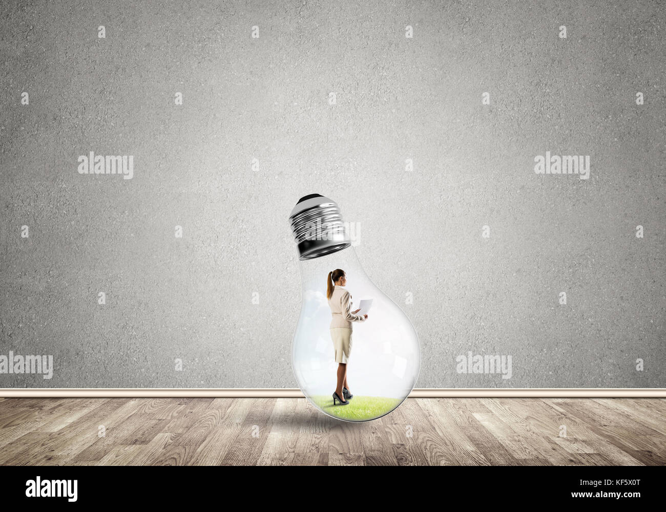 Businesswoman trapped in bulb Stock Photo - Alamy