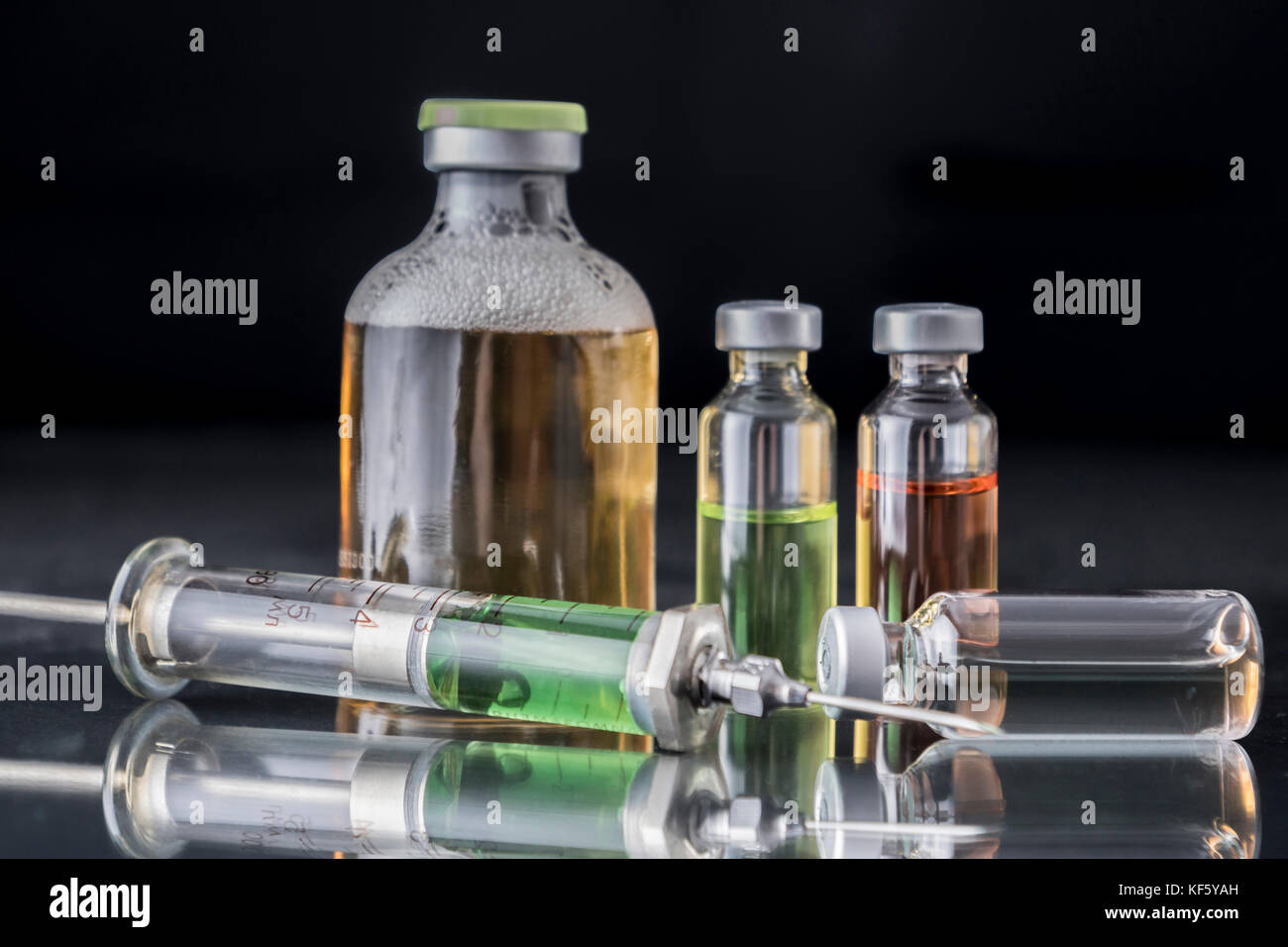 Several vials and syringe in laboratory, conceptual image Stock Photo - Alamy