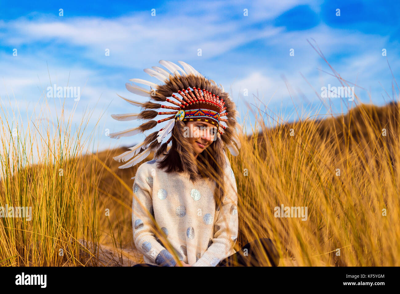 Beautiful young woman in black dotted white chief style Native American ...