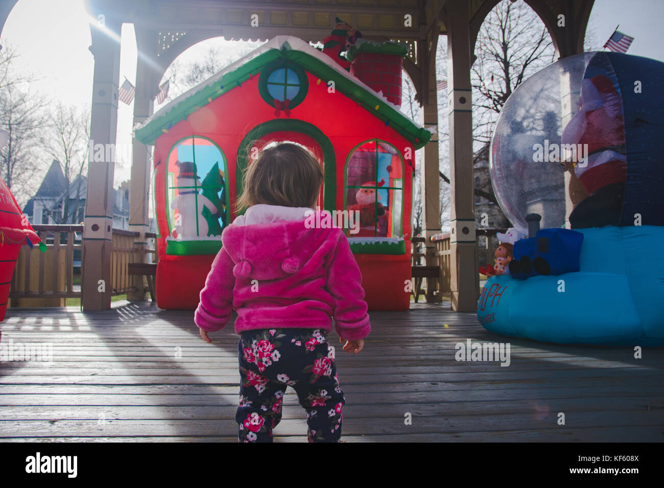 Toddler walking toward Christmas or holiday displays Stock Photo - Alamy