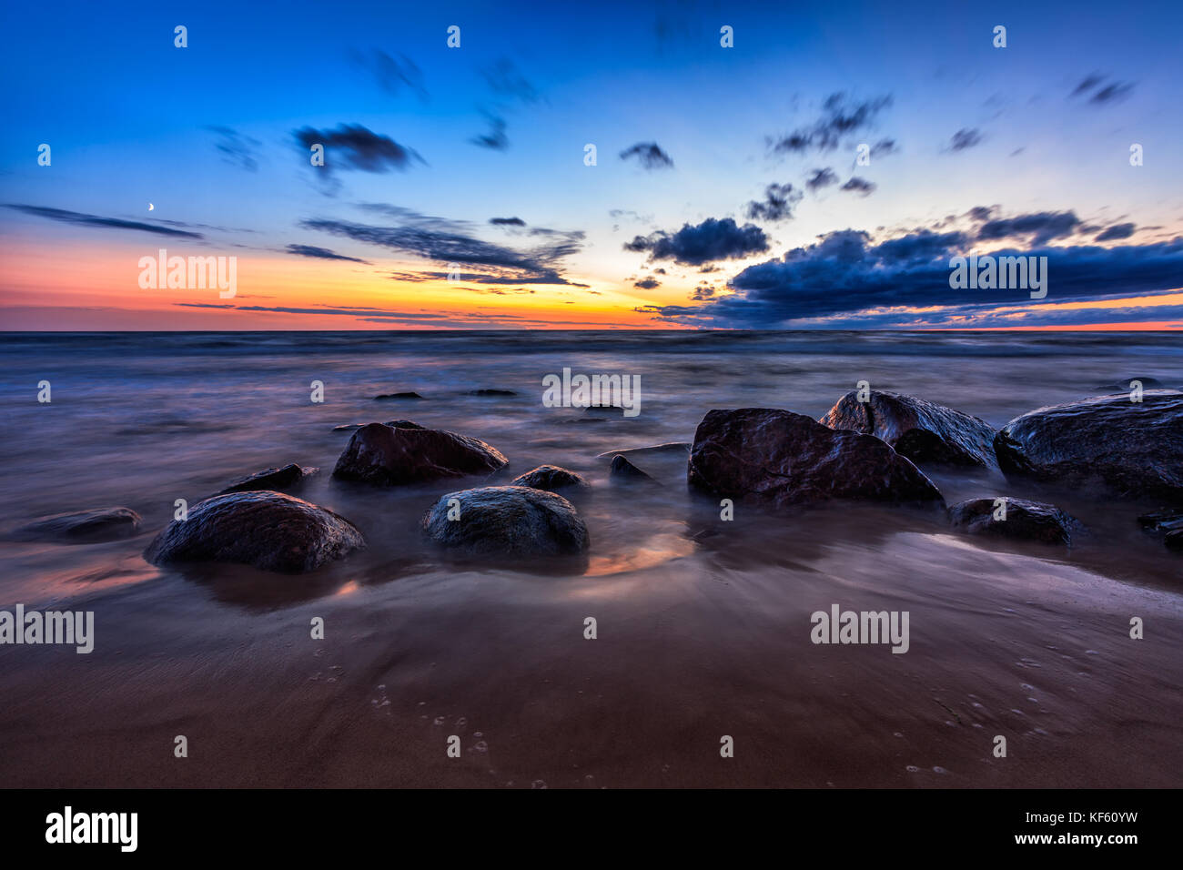 Sea sunset seascape with wet rocks Stock Photo - Alamy