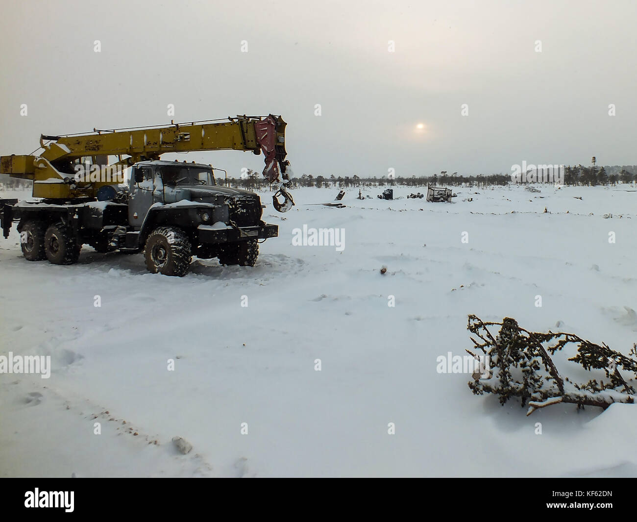 Mobile crane in the snow-covered field Stock Photo - Alamy