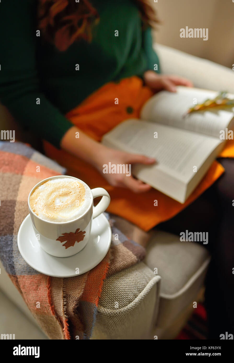 Cup of cappuccino coffee and girl reading a book Stock Photo - Alamy