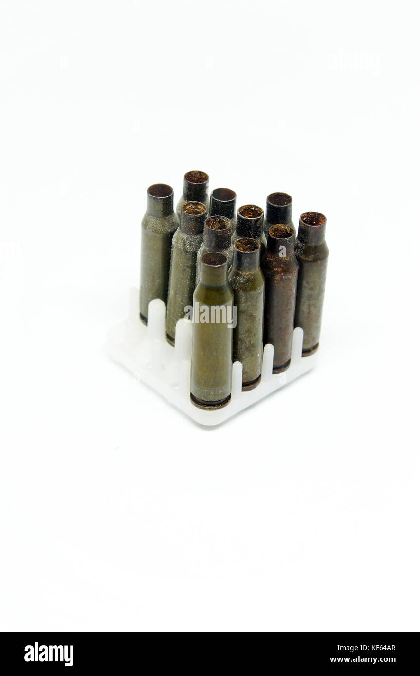 several shell casings and bullet on white background Stock Photo - Alamy