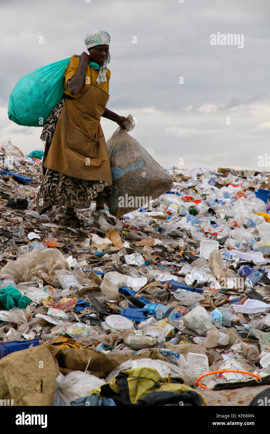 Living in the Kenya Slum Aerias - Woman collecting materials on the ...
