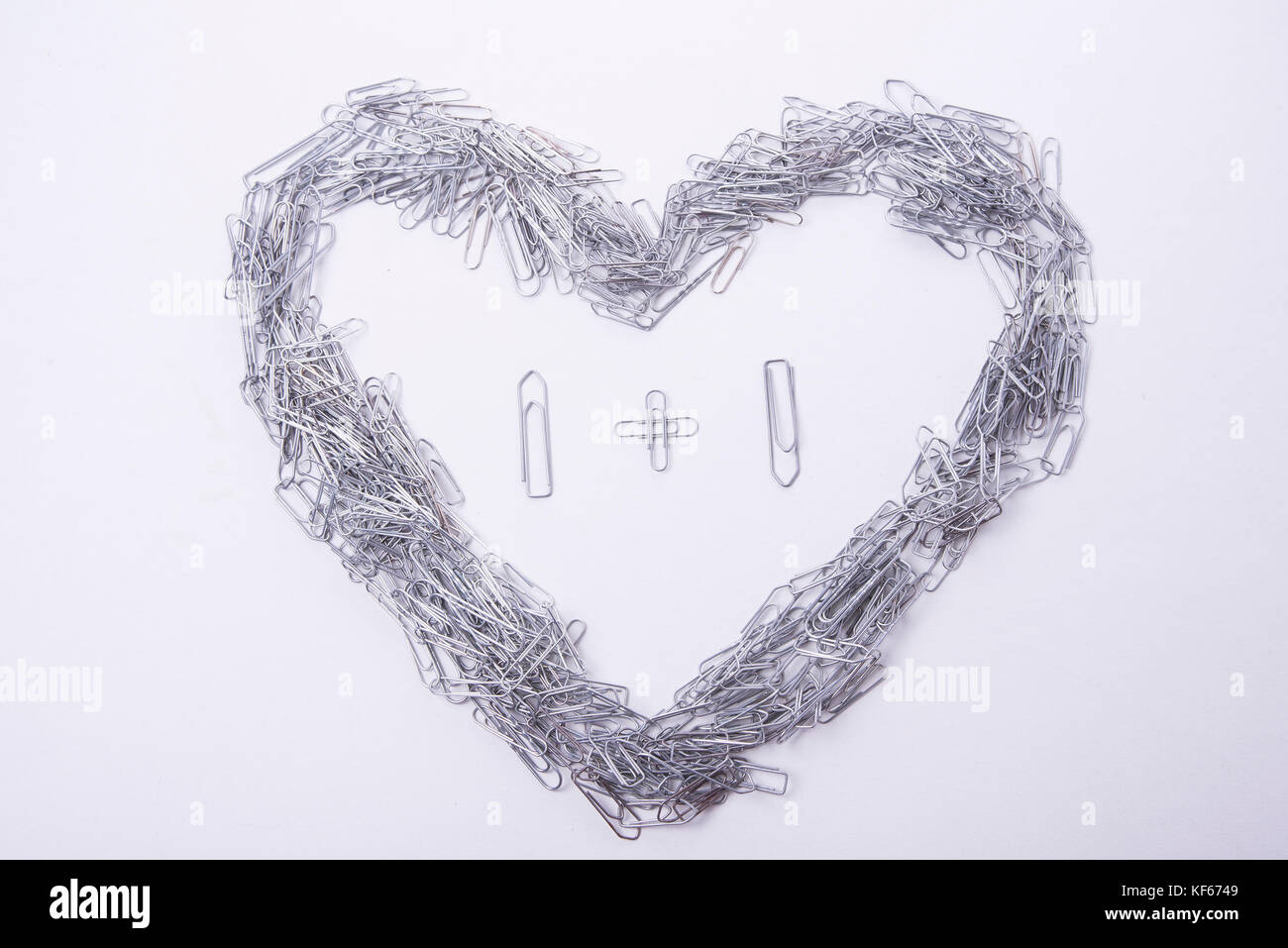 Heart make from paper clips on the white background Stock Photo - Alamy