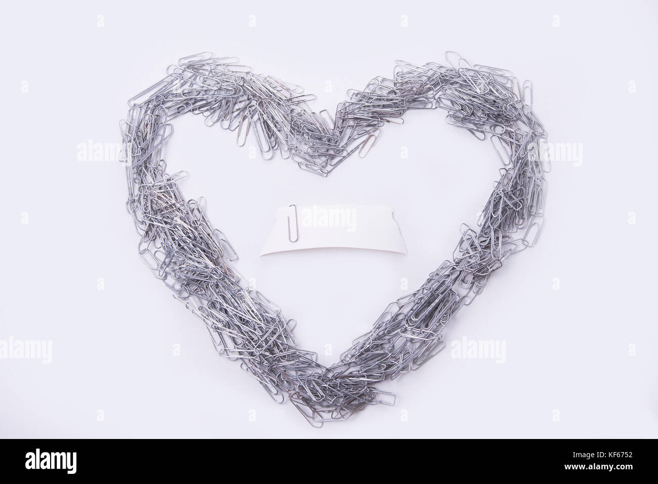 Heart make from paper clips on the white background Stock Photo - Alamy