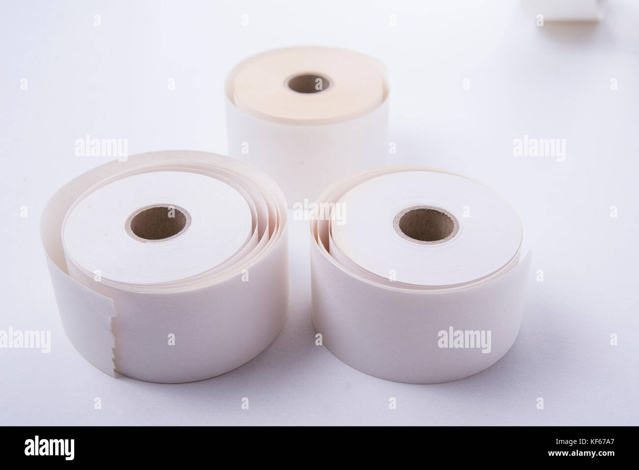 Three blank roll paper for cashiers on white background Stock Photo - Alamy