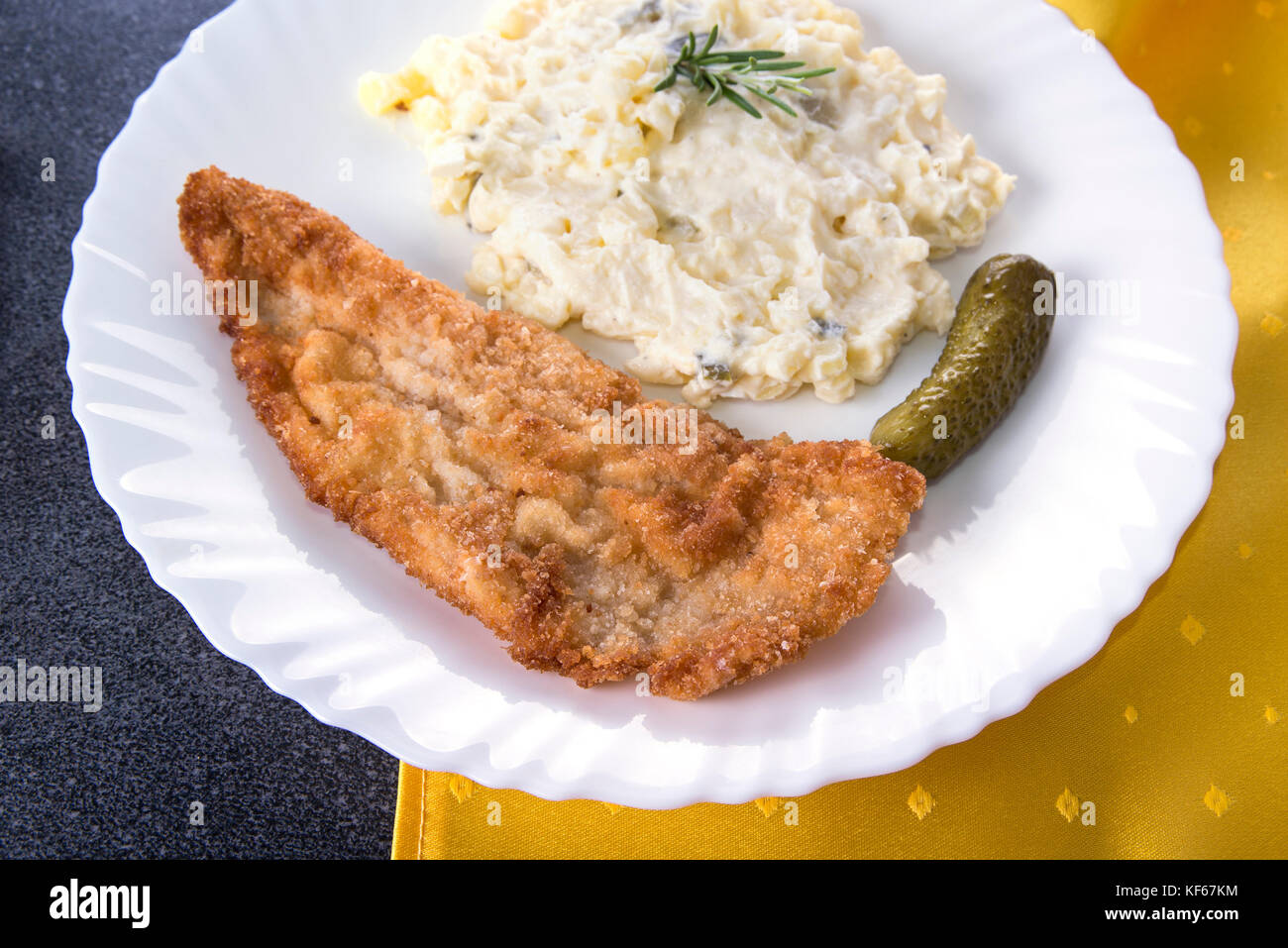 Fried pork meat with potato mayonnaise salad on the plate Stock Photo ...