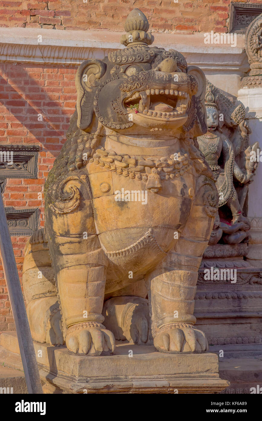 BHAKTAPUR, NEPAL - NOVEMBER 04, 2017: Close up of stone guardian statue ...