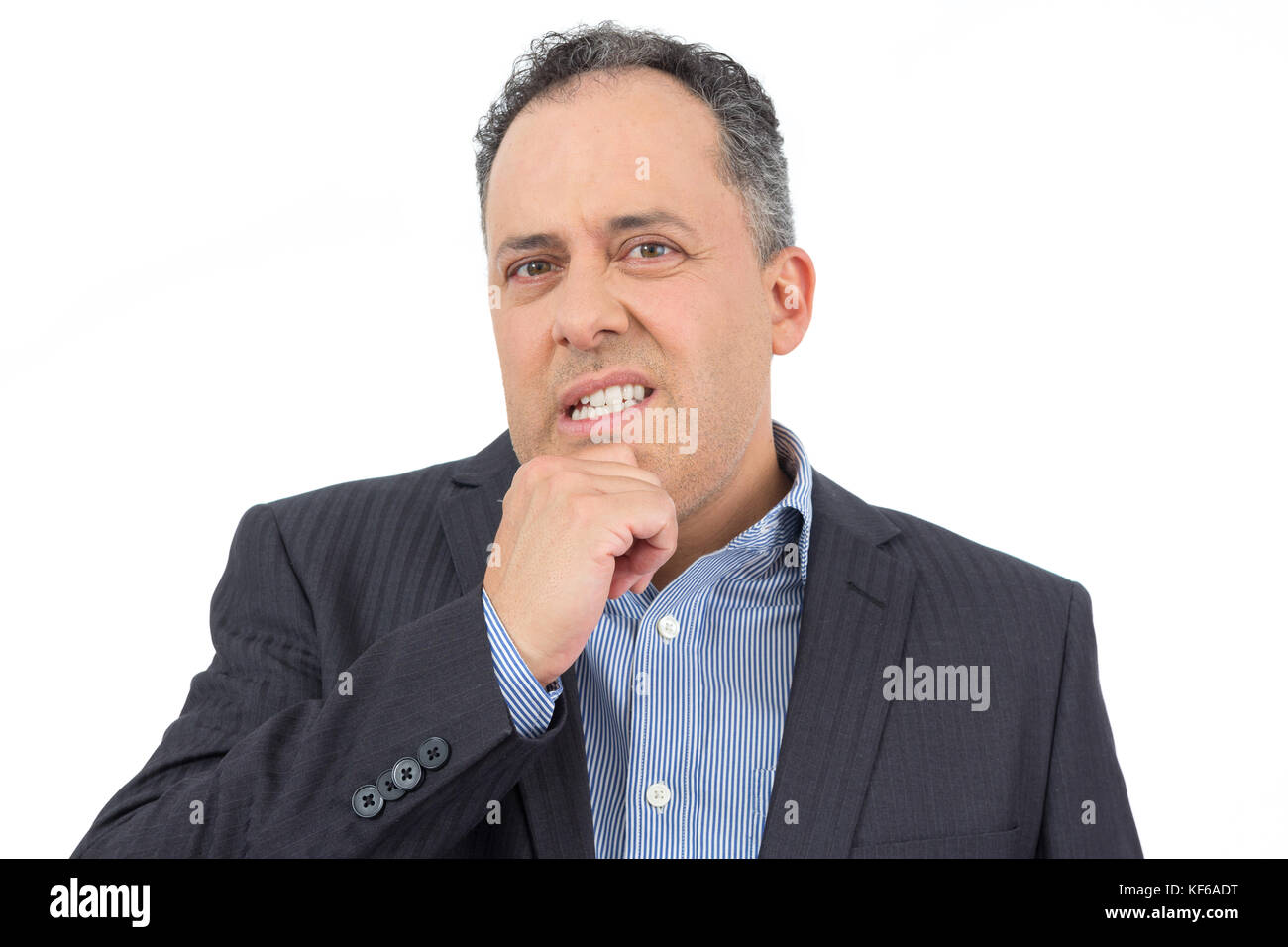 Undecided man has a hand on his chin. He has much doubt. He wears ...