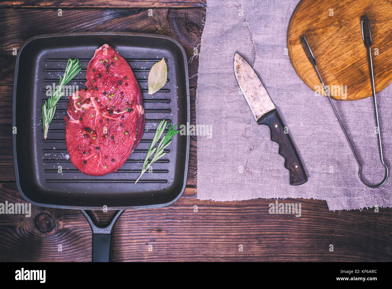raw beef with spices on a black square frying pan, top view Stock Photo ...