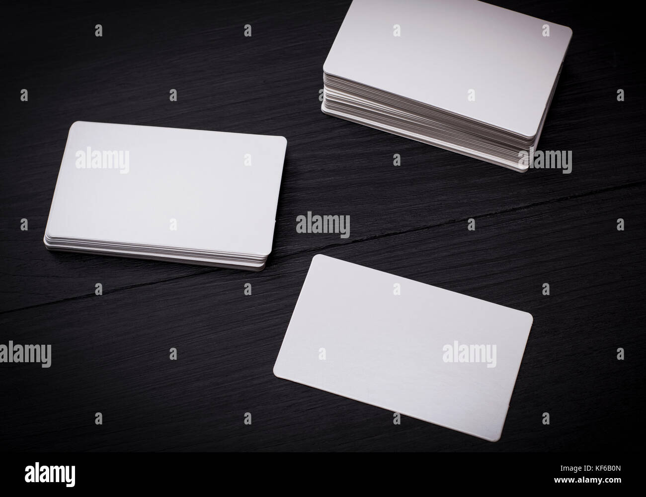 empty rectangular paper business card on a black wooden background ...