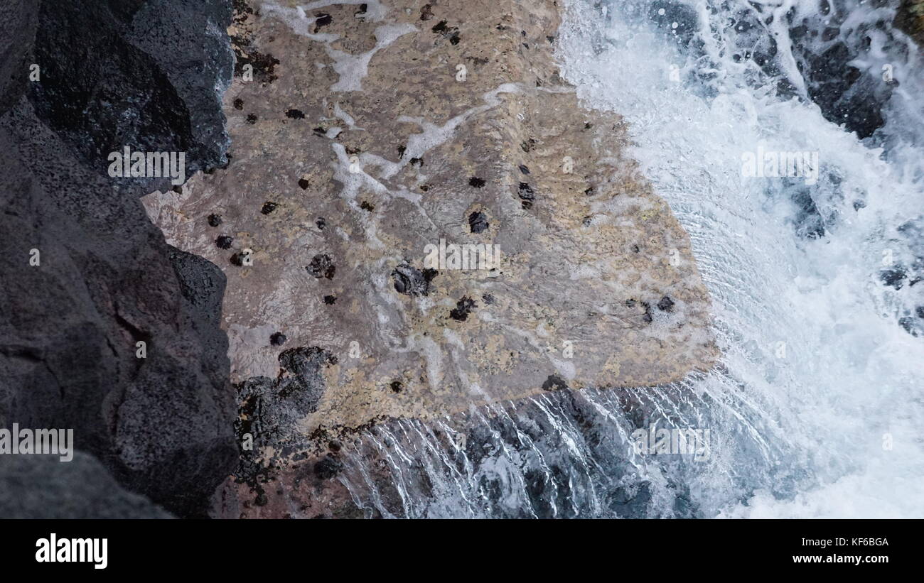 Water flowing over lava rock Stock Photo - Alamy