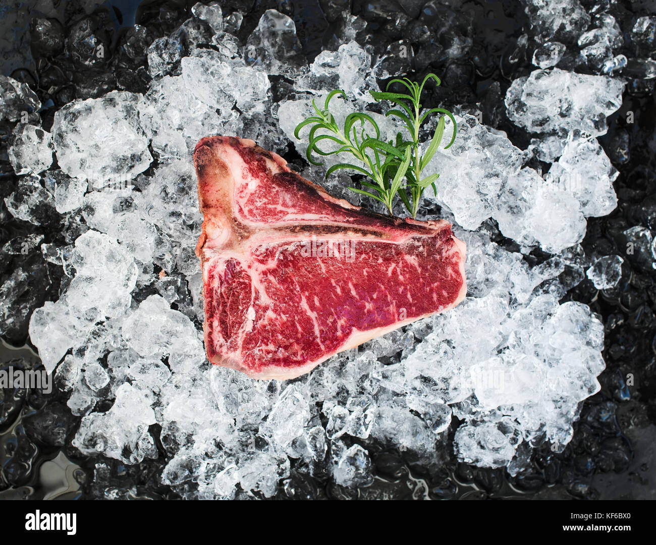 Raw fresh meat t-bone steak on chipped ice Stock Photo - Alamy