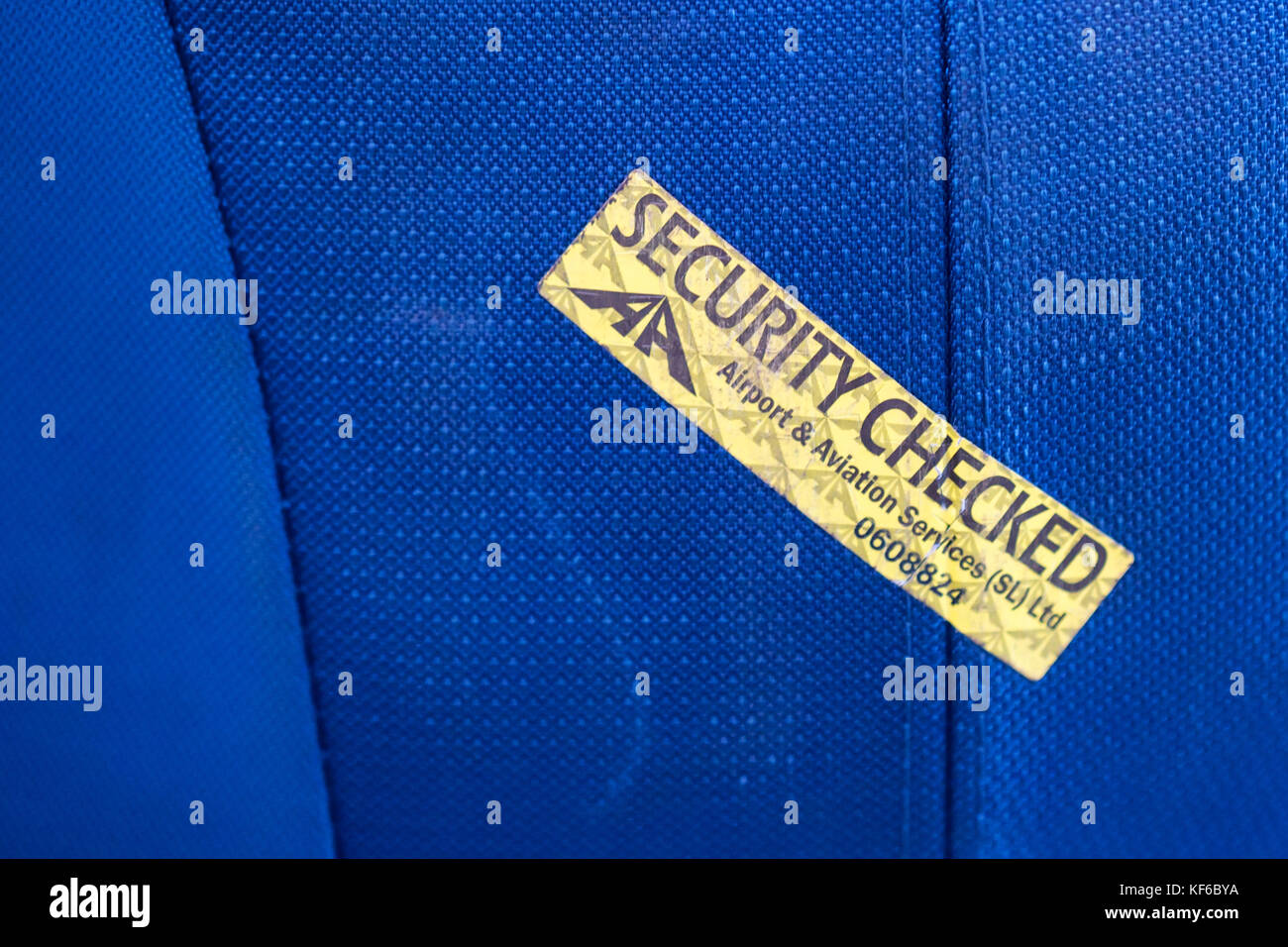 Close up security checked label on blue suitcase Stock Photo - Alamy