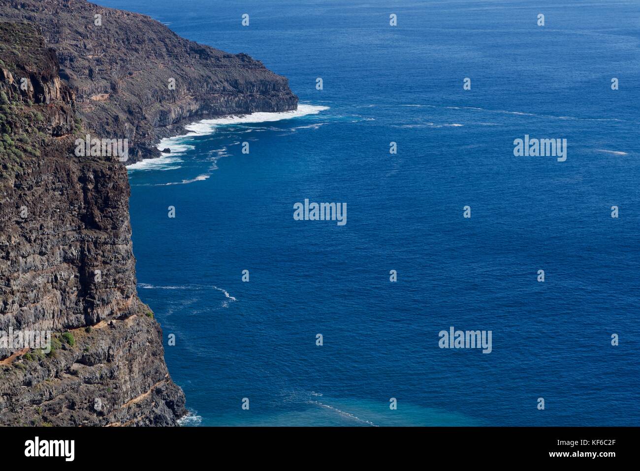 steep coast at the blue ocean of the canary islands Stock Photo - Alamy