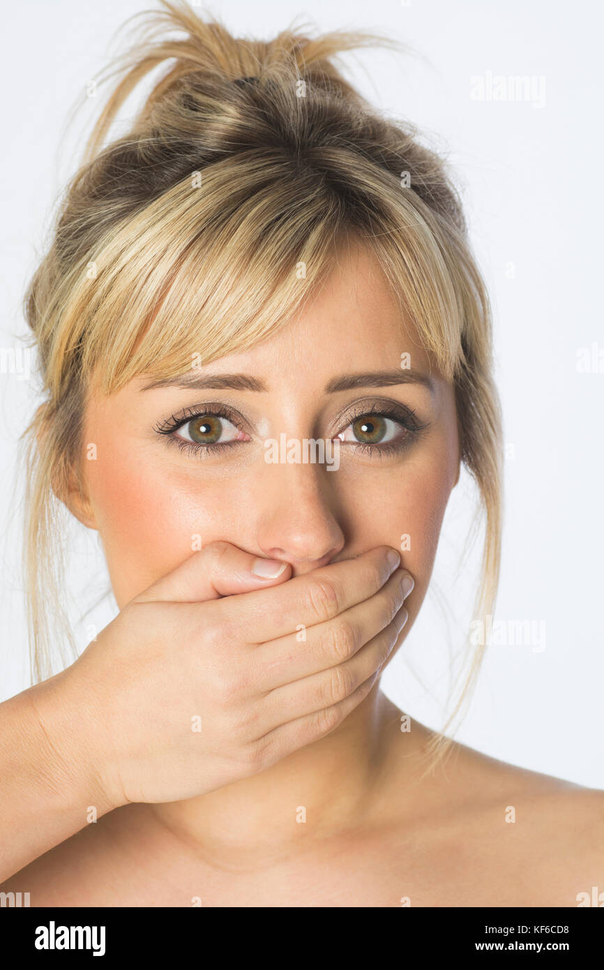 Woman covering mouth with hand hi-res stock photography and images - Alamy
