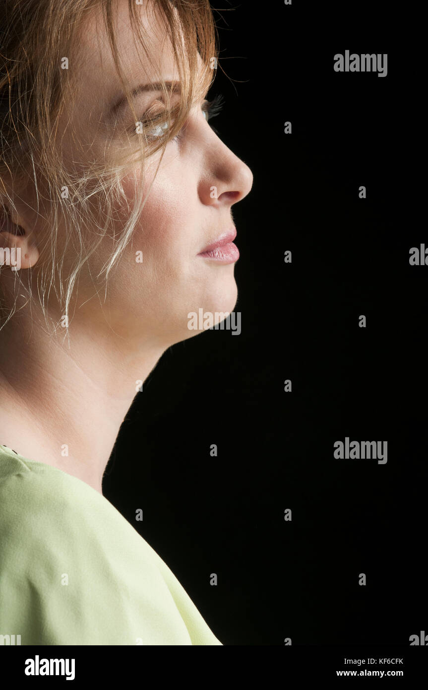 Profile of a pensive mature woman looking away Stock Photo - Alamy