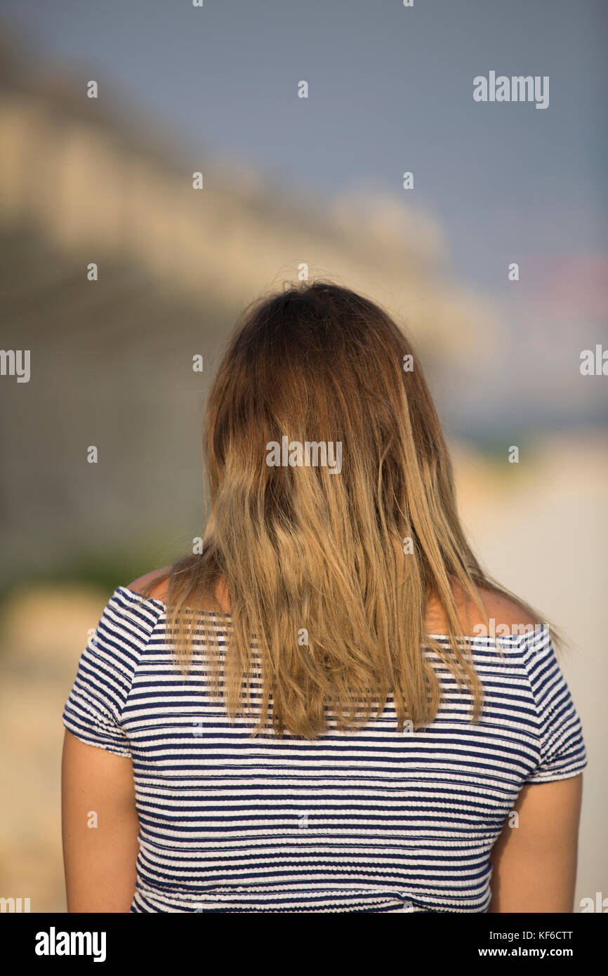 Rear view of a young woman walking outdoors Stock Photo - Alamy