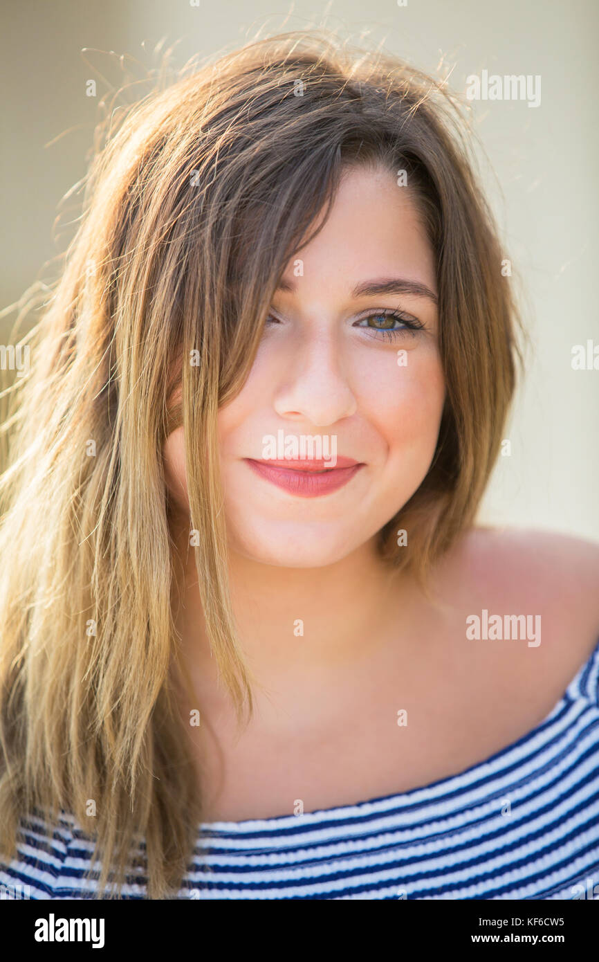 Happy young woman smiling outdoors hair covering face Stock Photo - Alamy