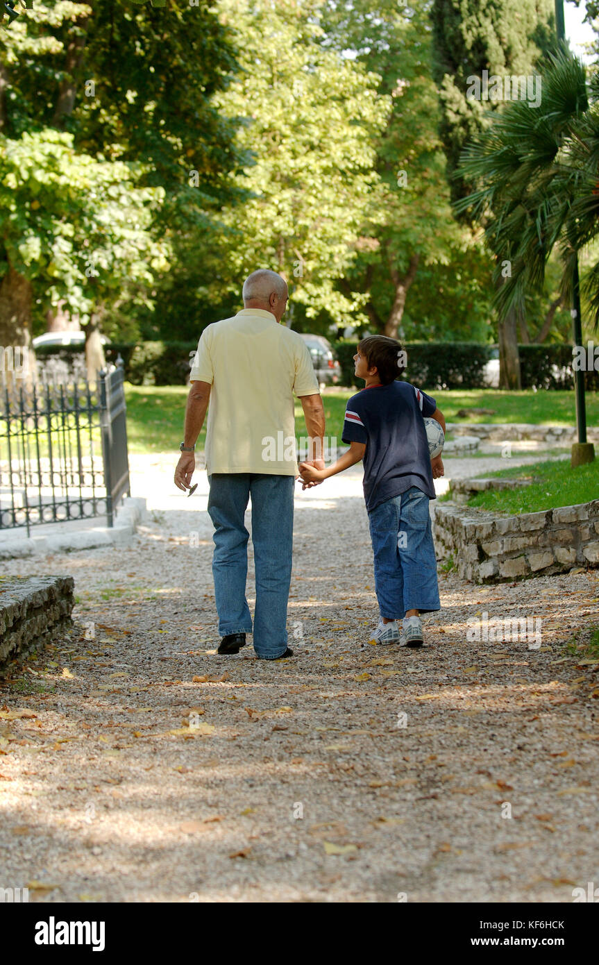 Grandfather and grandson playing in park Credit © Luigi Innamorati ...