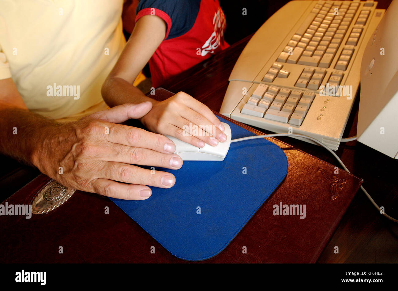Grandfather and grandchildren at computer, hands on the pc mouse Credit ...