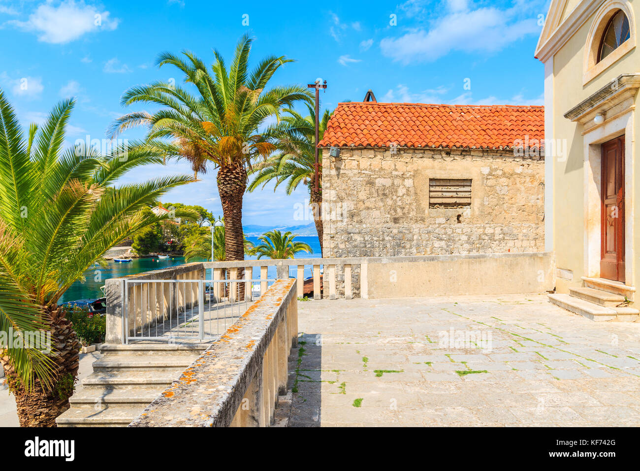 Square with old buildings in front of a church in Splitska village ...
