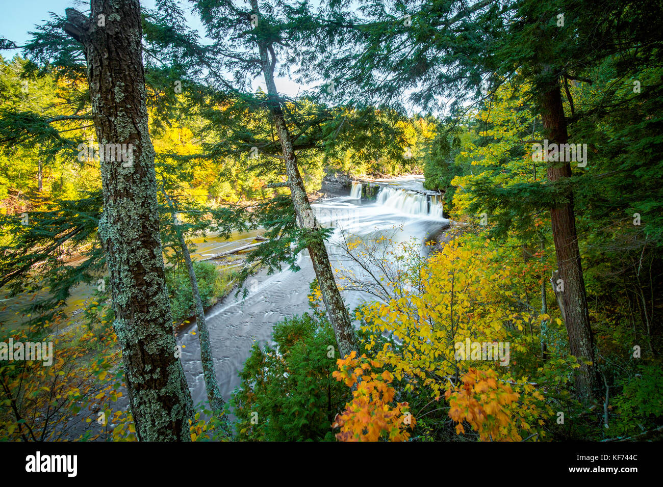 Waterfall Peering Through Autumn Trees Stock Photo - Alamy