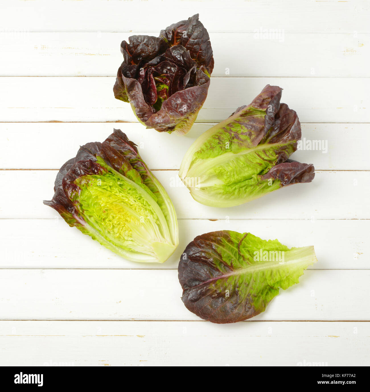 two and half heads of fresh lettuce on white wooden background Stock ...