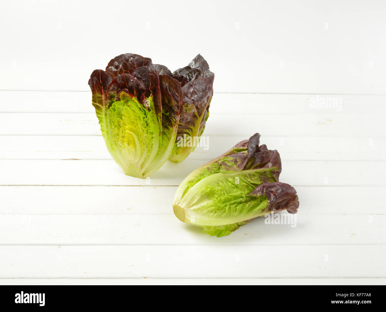 two and half heads of fresh lettuce on white wooden background Stock ...