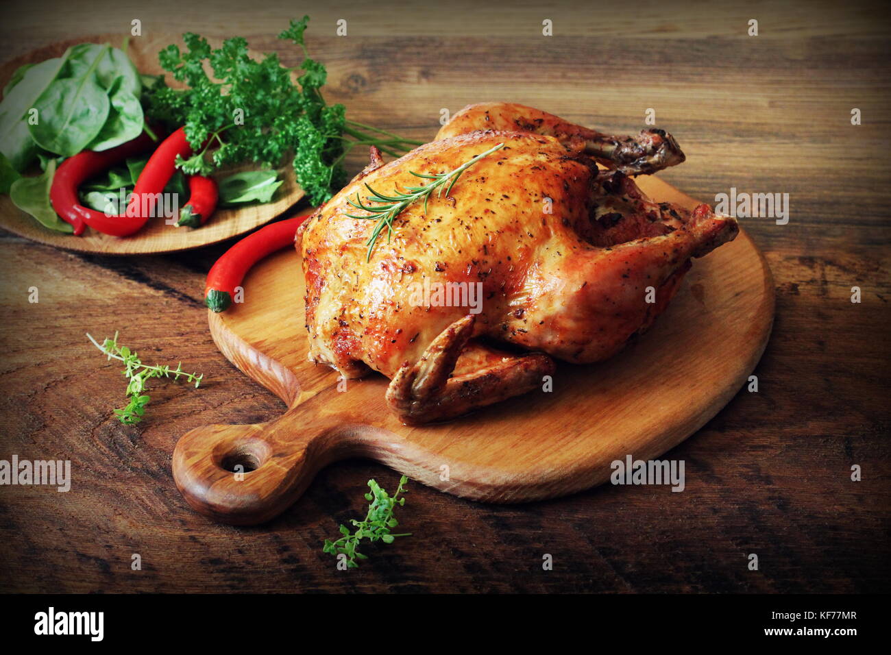 Whole roasted chicken on cutting board. Wooden rustic background Stock ...