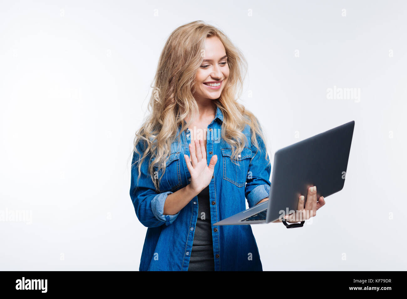 Cheerful young woman making a video call Stock Photo - Alamy