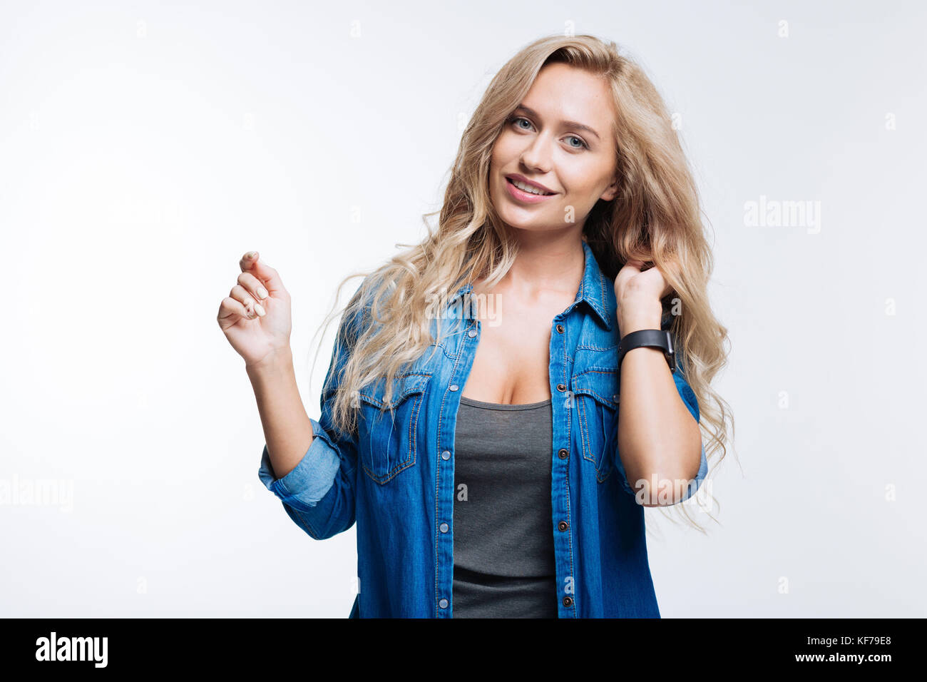 Beautiful woman posing with her hand in hair Stock Photo - Alamy