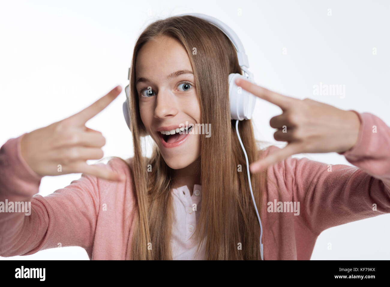 Close up of teenage girl showing sign of horns Stock Photo - Alamy