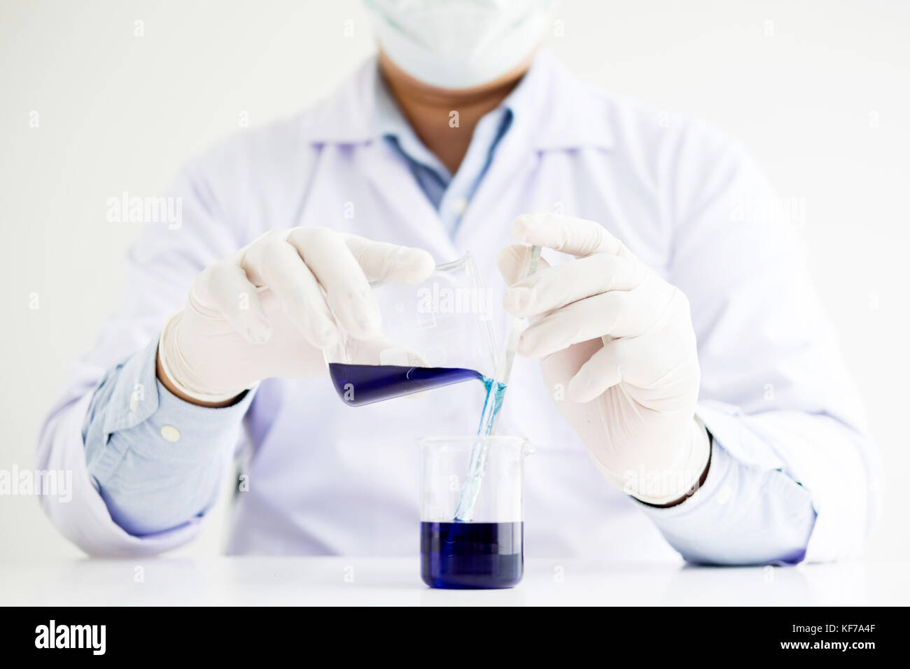 scientists and scientific equipment Pouring mixing reagents liqiud ...