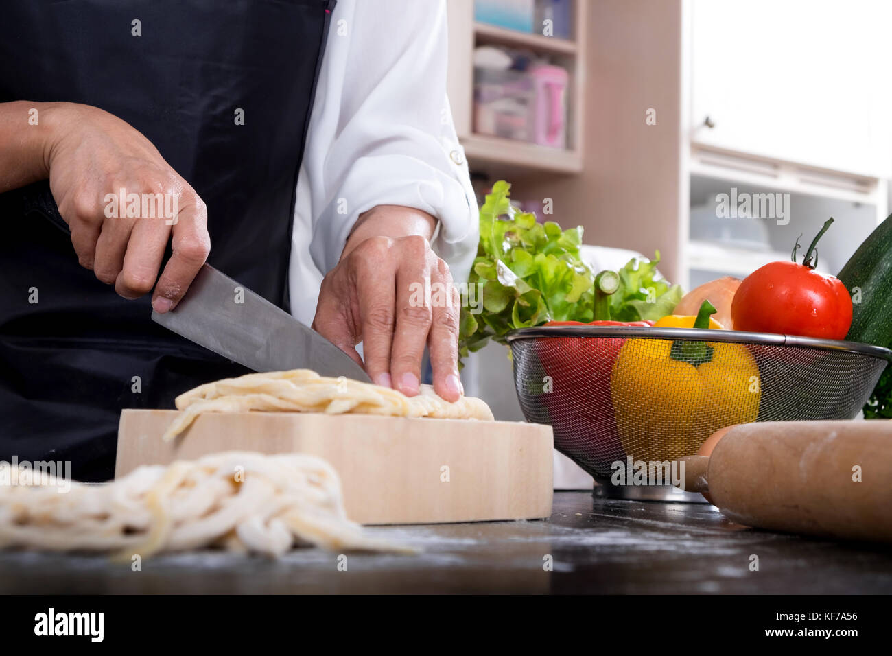 Chef Cutting cook Homemade makes dough fresh Pasta Stock Photo - Alamy