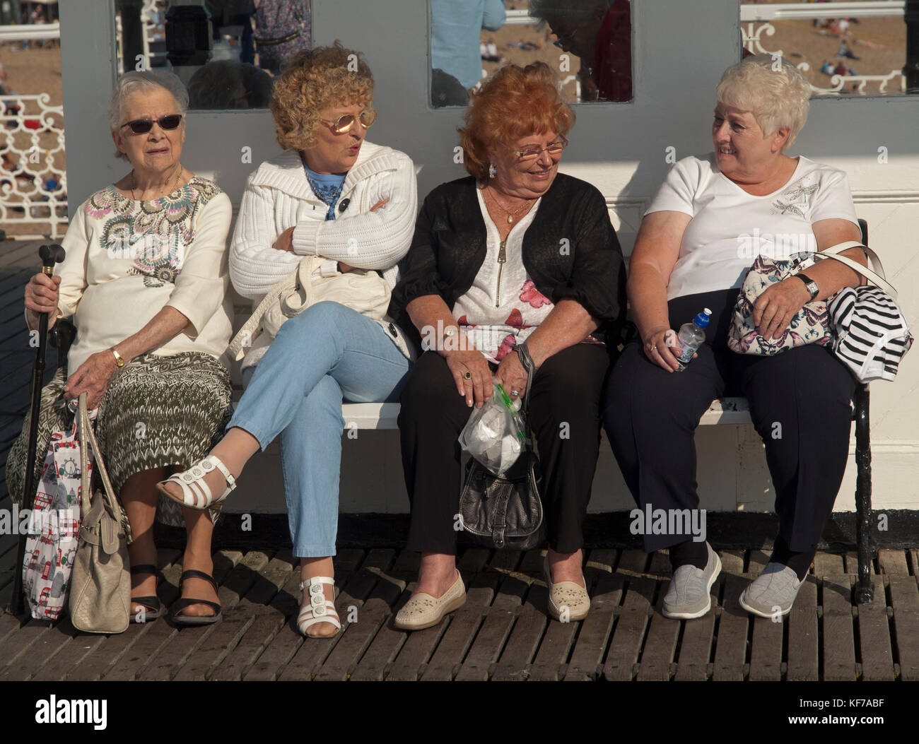 Women sitting on benches hi-res stock photography and images - Alamy