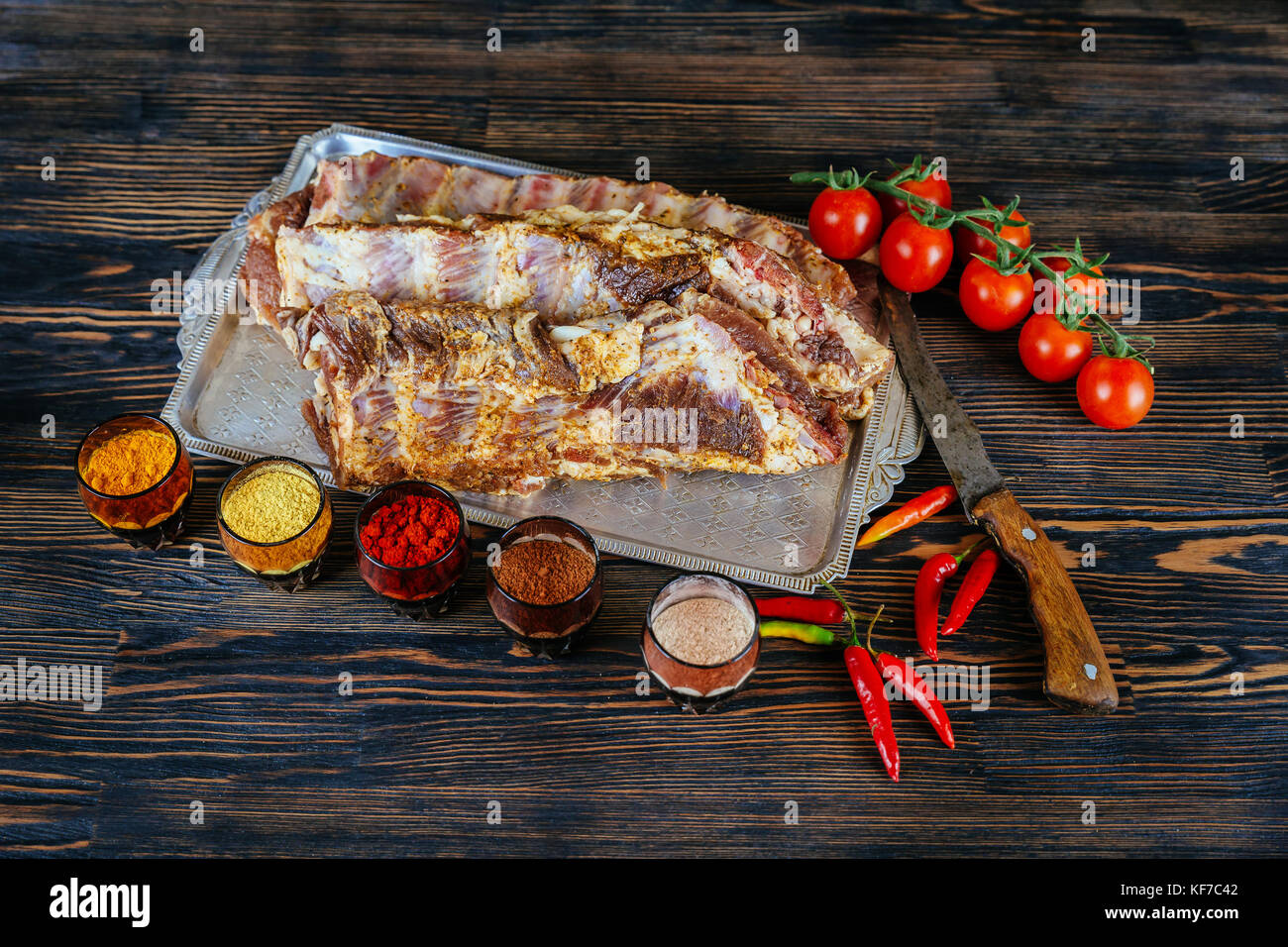 Raw uncooked Pork ribs on wooden cut board ready to cook with ...