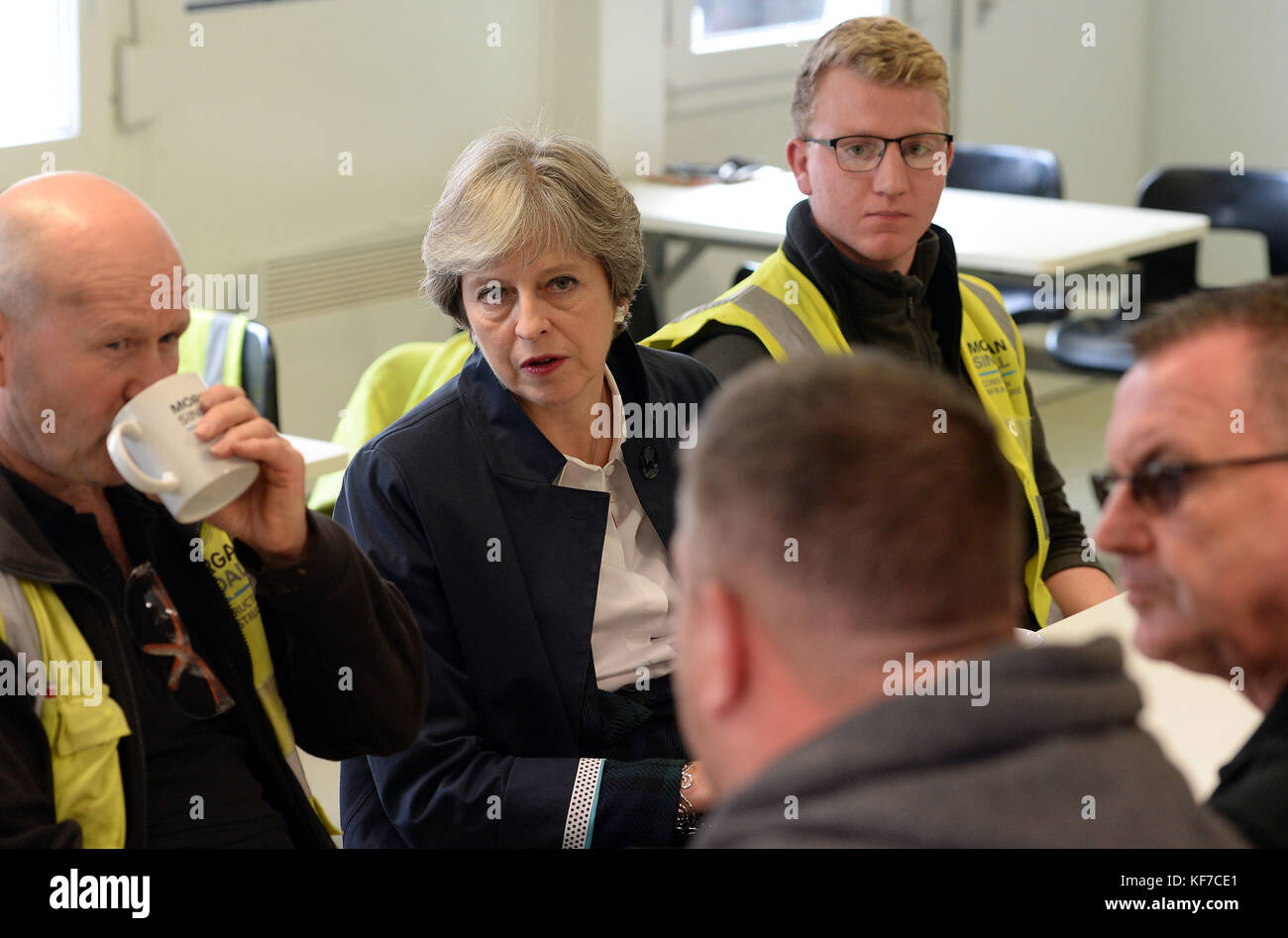 Prime Minister Theresa May talks to construction workers during a visit ...
