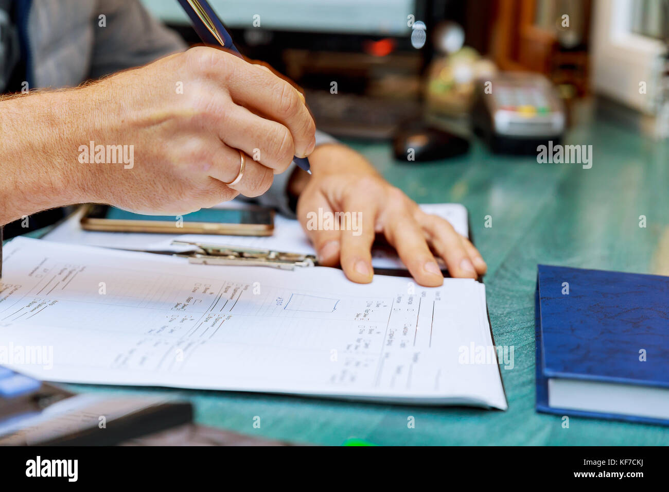 Close up of male accountant making calculations. Man writing something ...