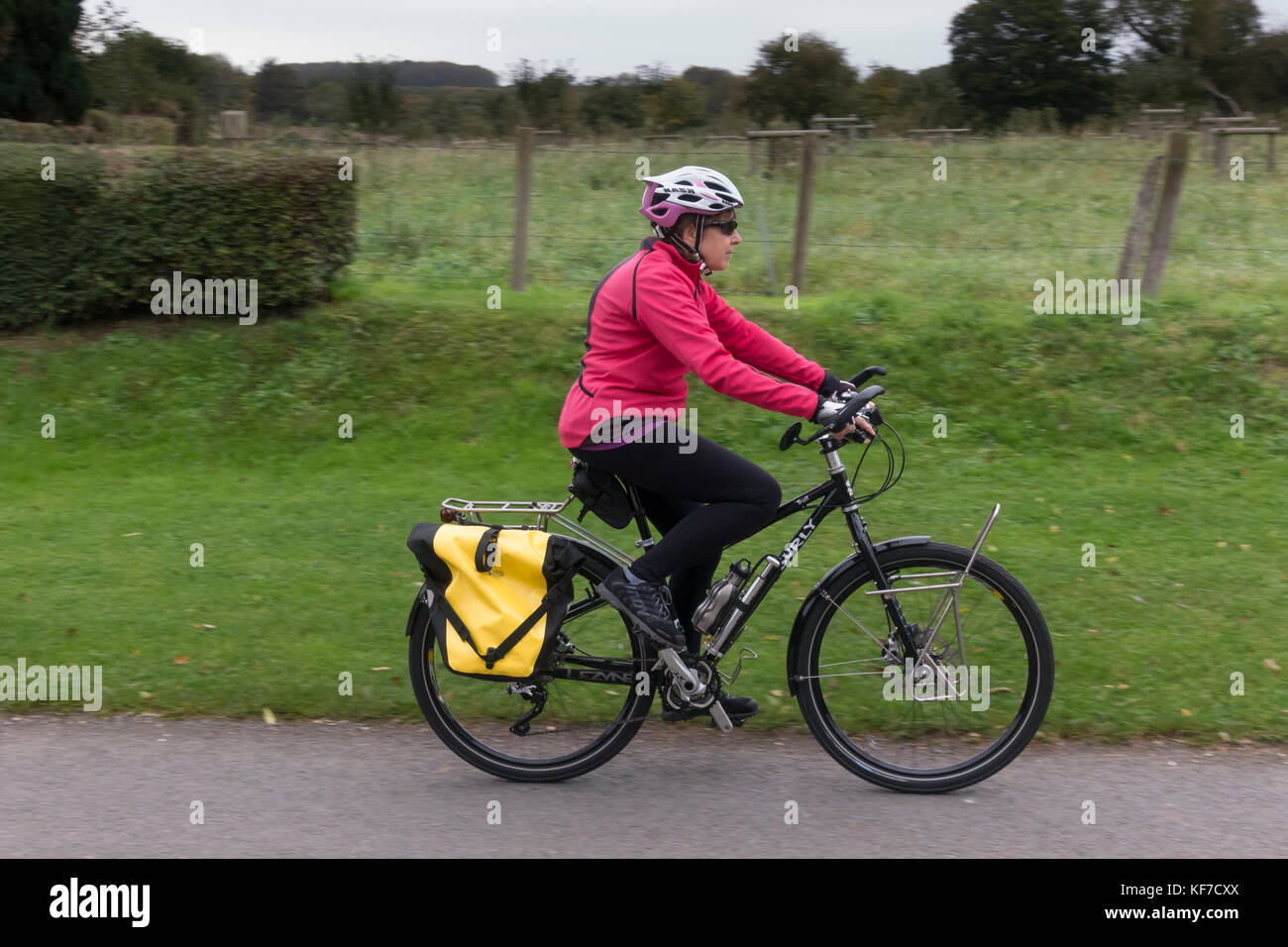 Female Cycling along a road Stock Photo - Alamy