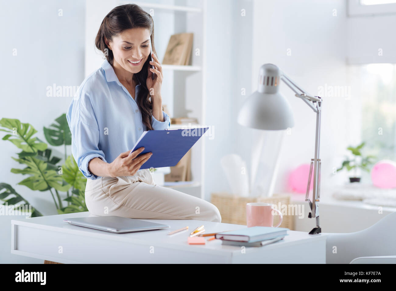 Positive nice woman working in the office Stock Photo - Alamy