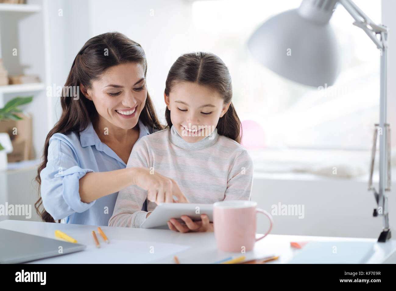 Cute positive girl reading a book Stock Photo - Alamy